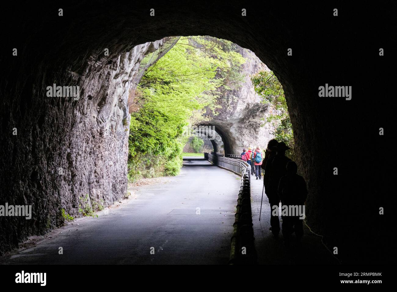 Japan, Kyushu, Yabakei Region. Walking through the Ao-no-domon Tunnel ...