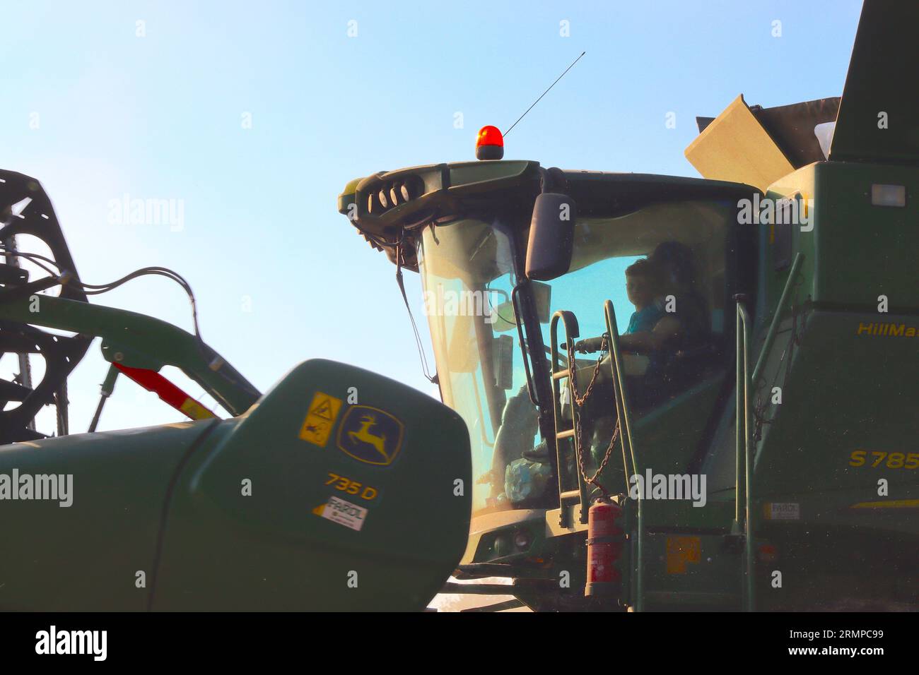 Combine operator commences another row to harvest the wheat crop in a ...