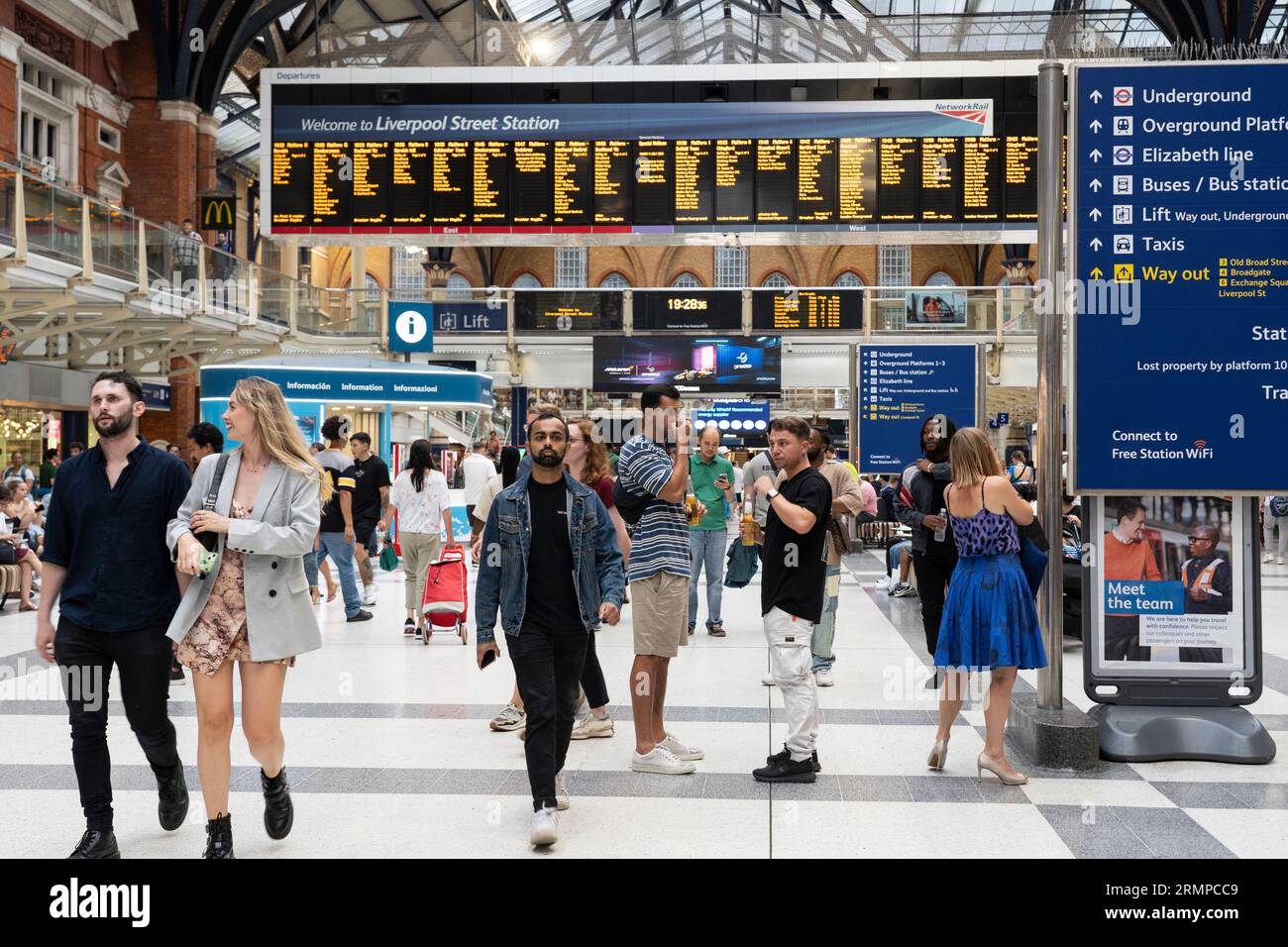 Rail passengers walking through Liverpool Street train station with a ...