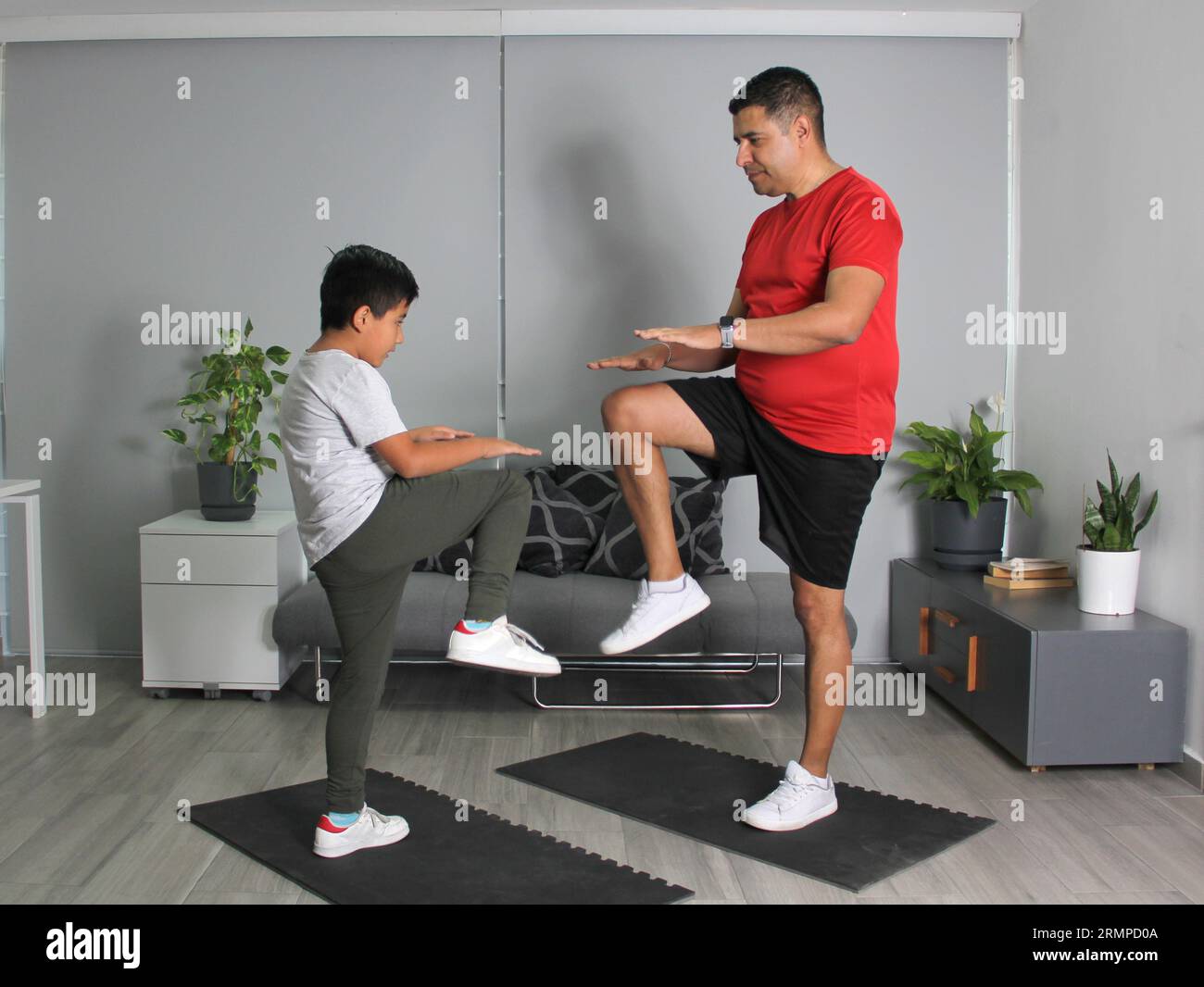 Latino dad and son have exercised together in their living room to lose ...