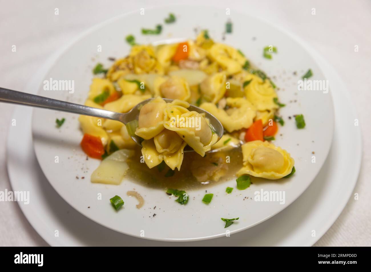 Traditional Italian tortellini (capeletti, agnolini) soup with chicken ...