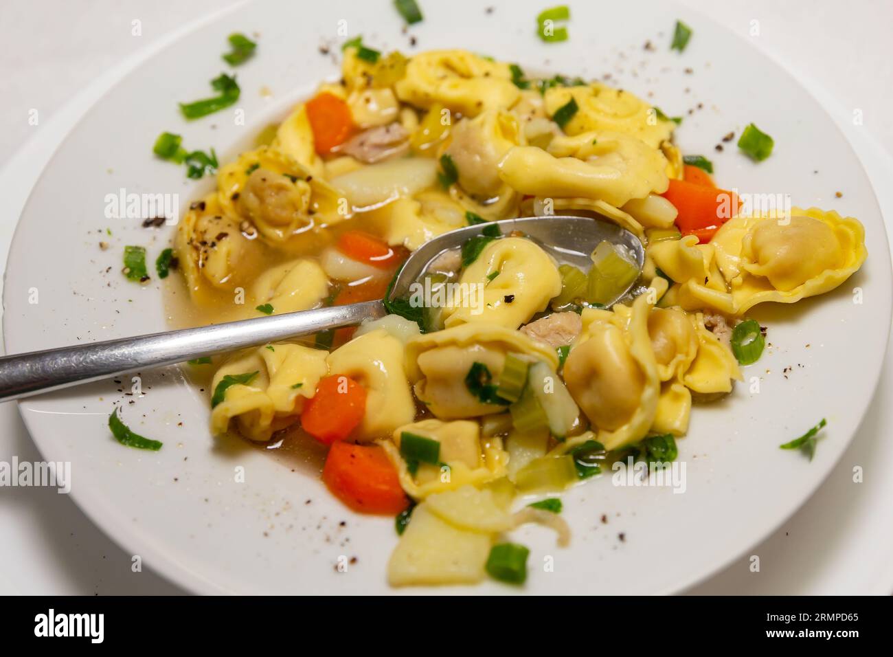 Traditional Italian tortellini (capeletti, agnolini) soup with chicken ...