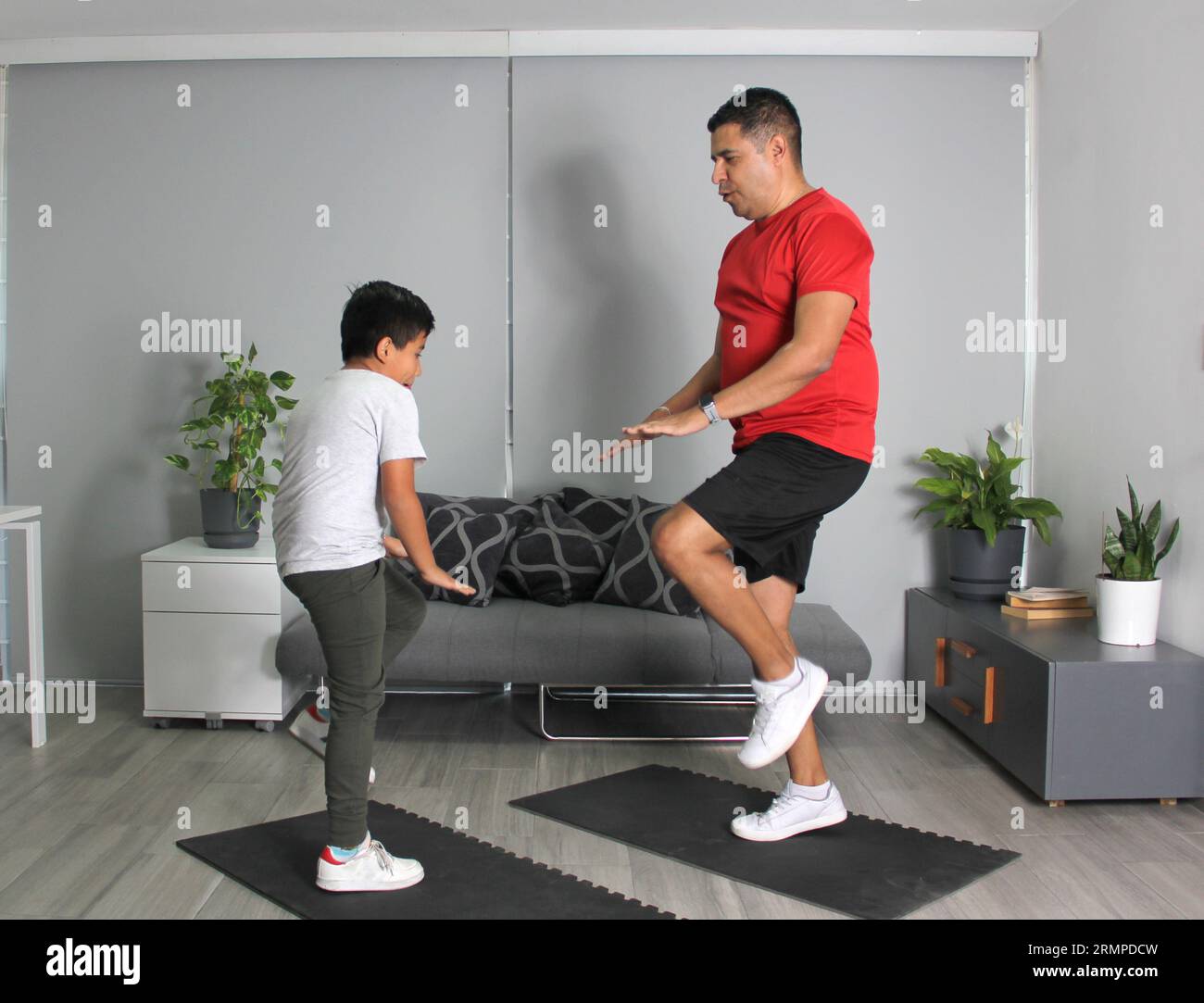 Latino dad and son have exercised together in their living room to lose ...