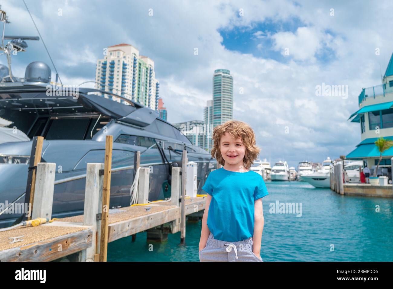 Kid play on Miami marine. Lifestyle closeup portrait of funny kids face ...