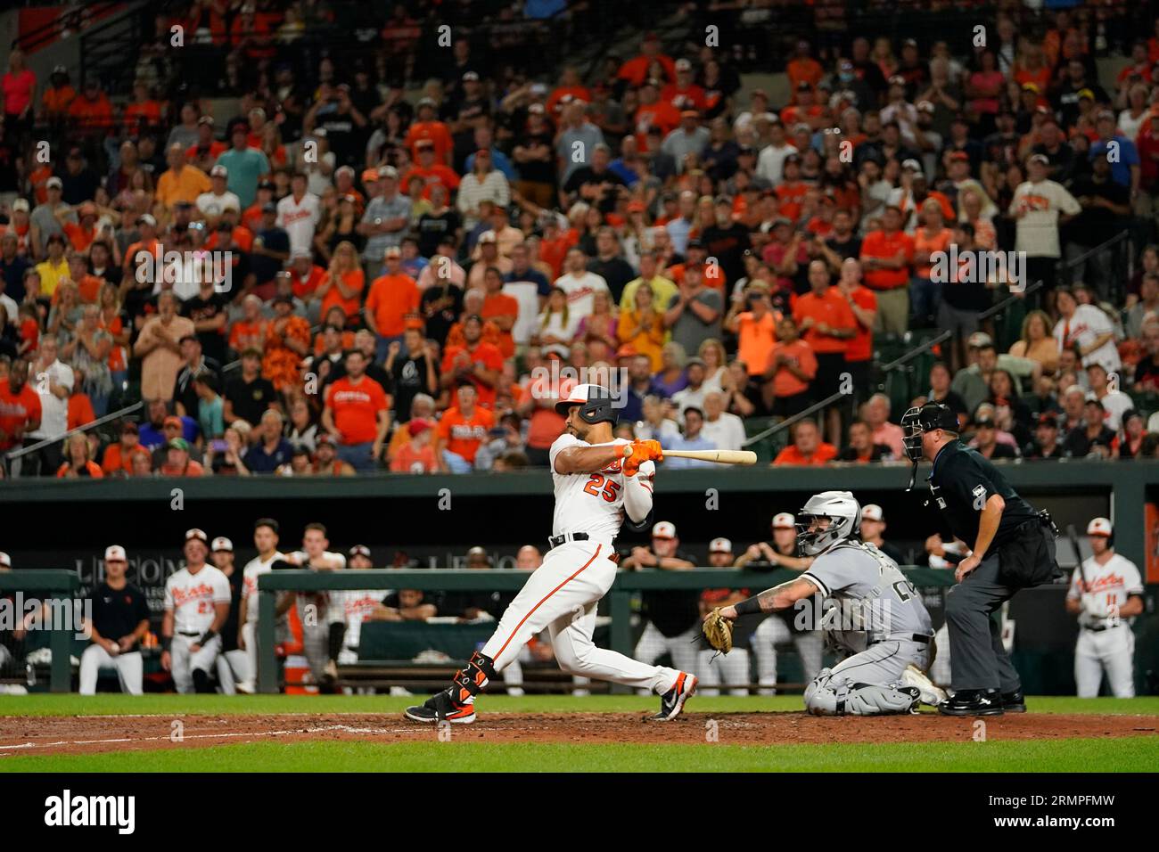 Baltimore Orioles' Anthony Santander (25) follows through on a swing ...