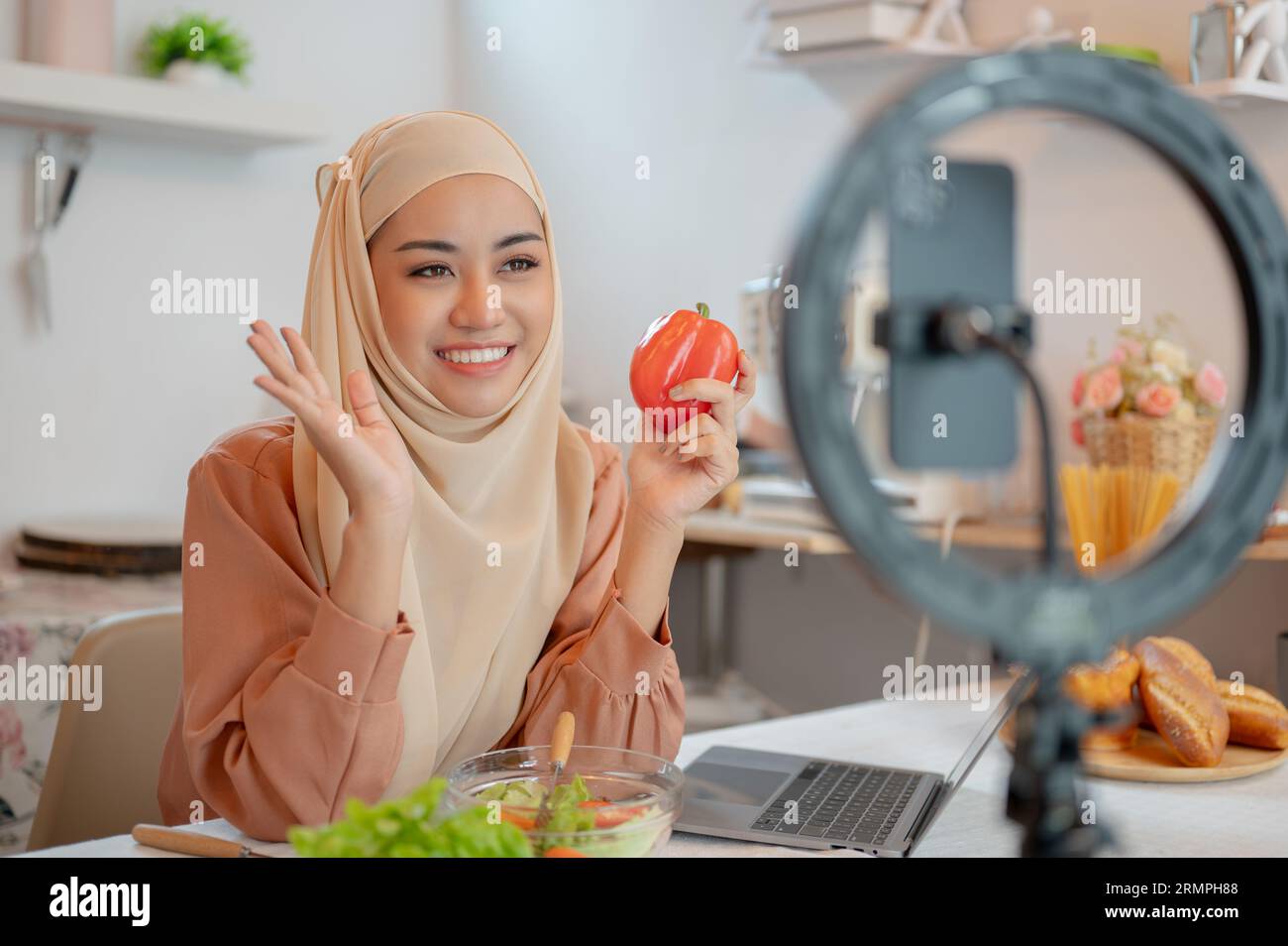 A beautiful Asian Muslim female food blogger or content creator is live ...