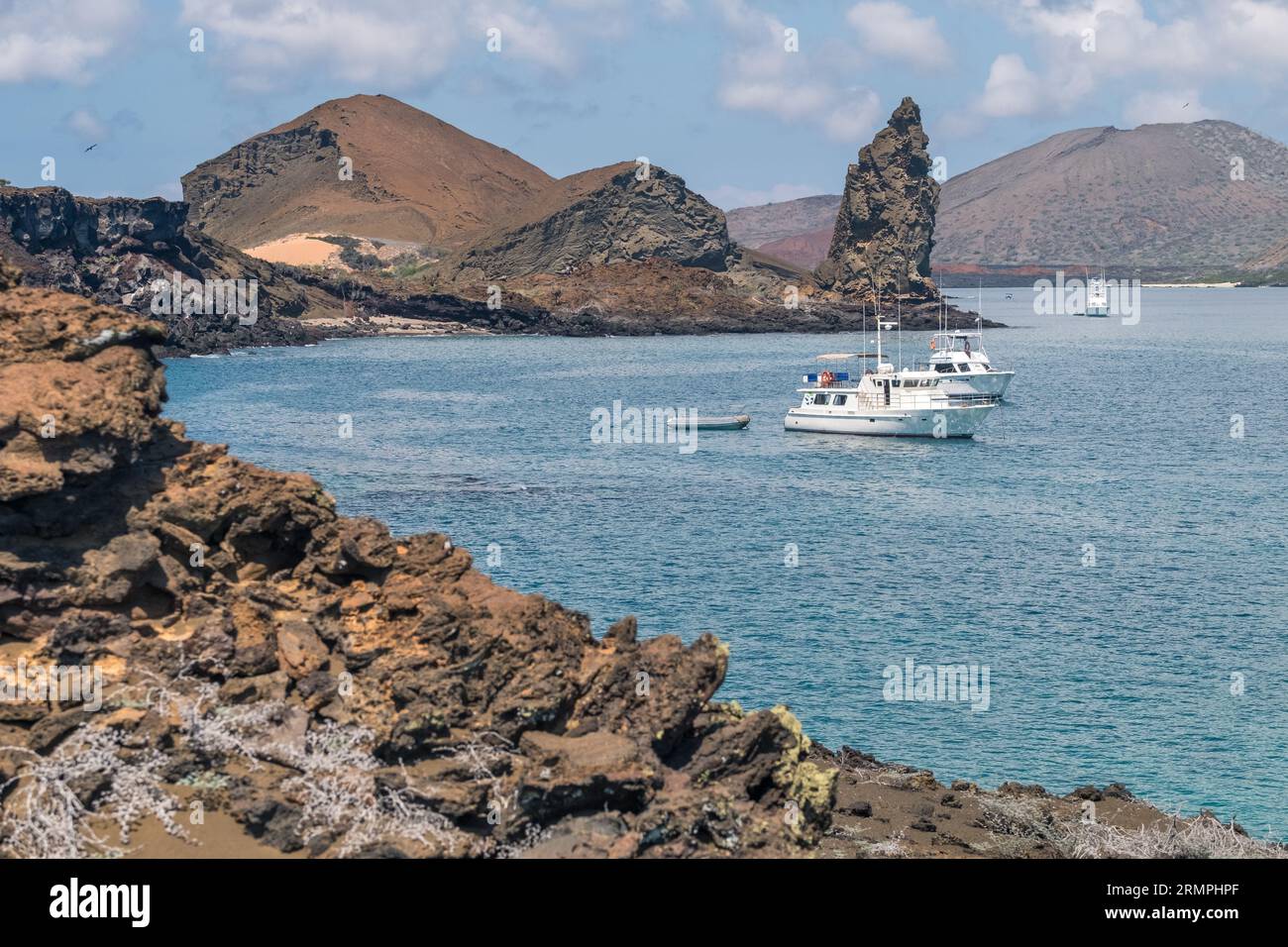 A vertical shot of two yachts sailing in the ocean at Galapagos Islands ...
