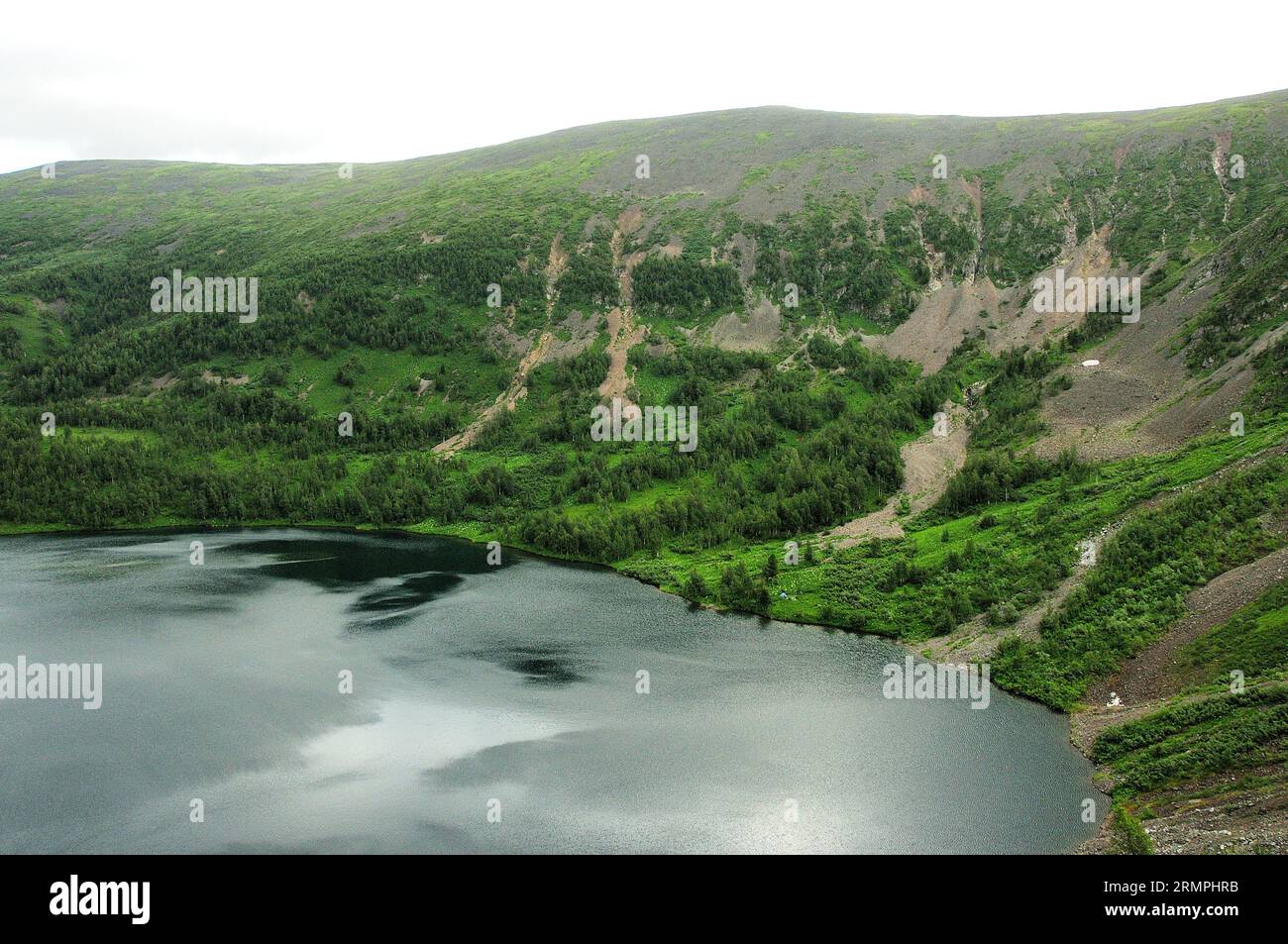 A huge lake in an intermountain basin under a cloudy summer sky ...