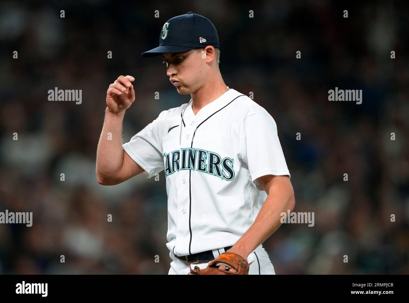 Seattle Mariners starting pitcher Luke Weaver walks off the field after ...
