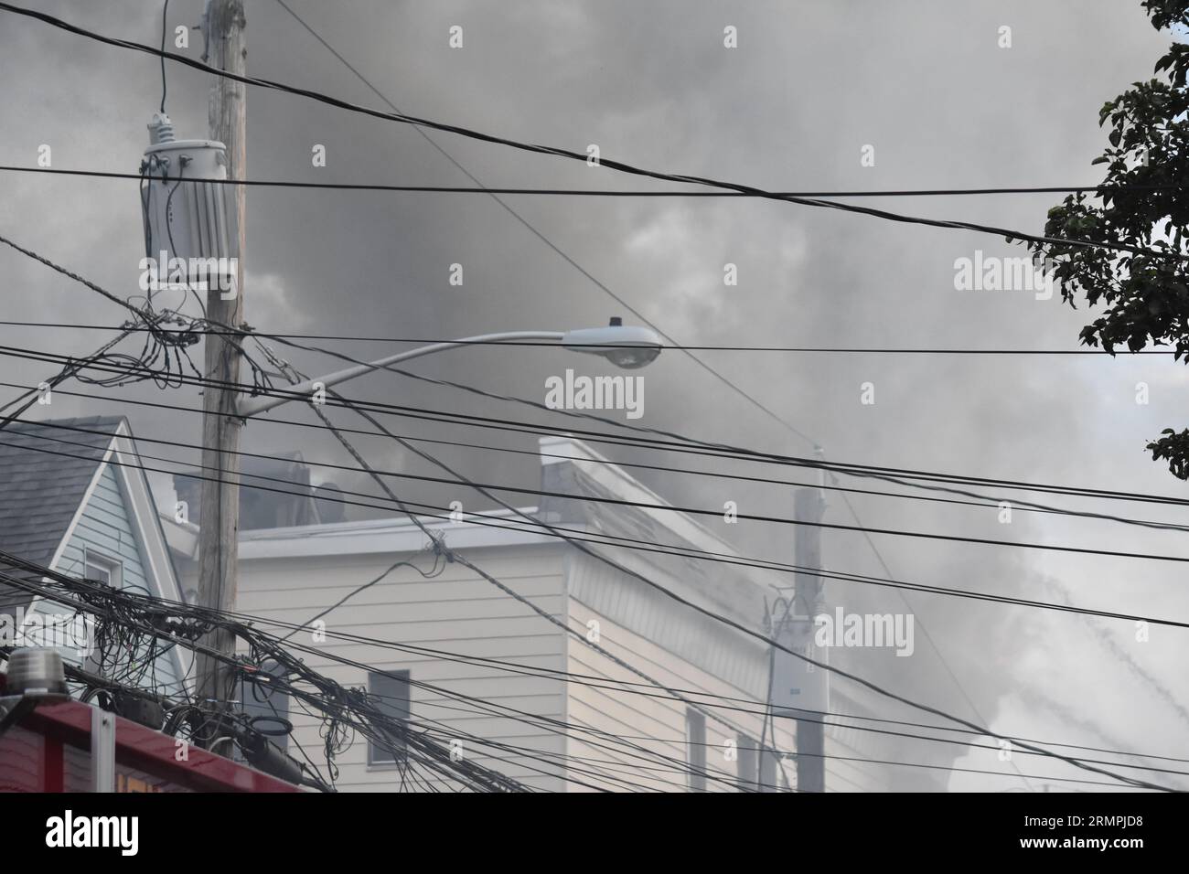 Newark, United States. 29th Aug, 2023. Flames shoot out of the roof of ...
