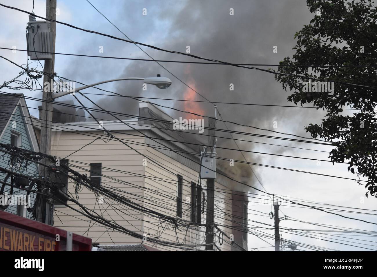 Newark, United States. 29th Aug, 2023. Flames shoot out of the roof of ...