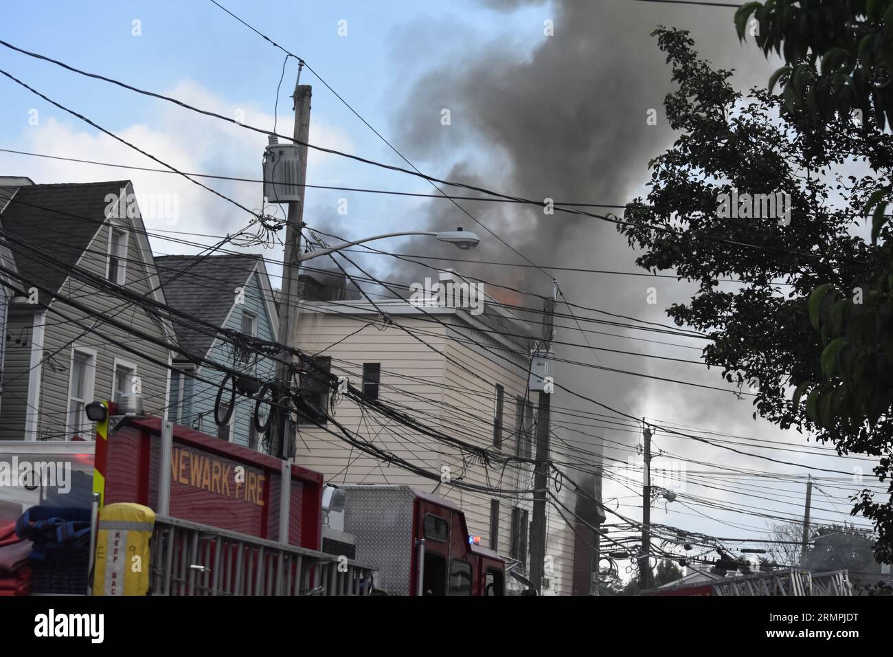 Newark, United States. 29th Aug, 2023. Flames shoot out of the roof of ...