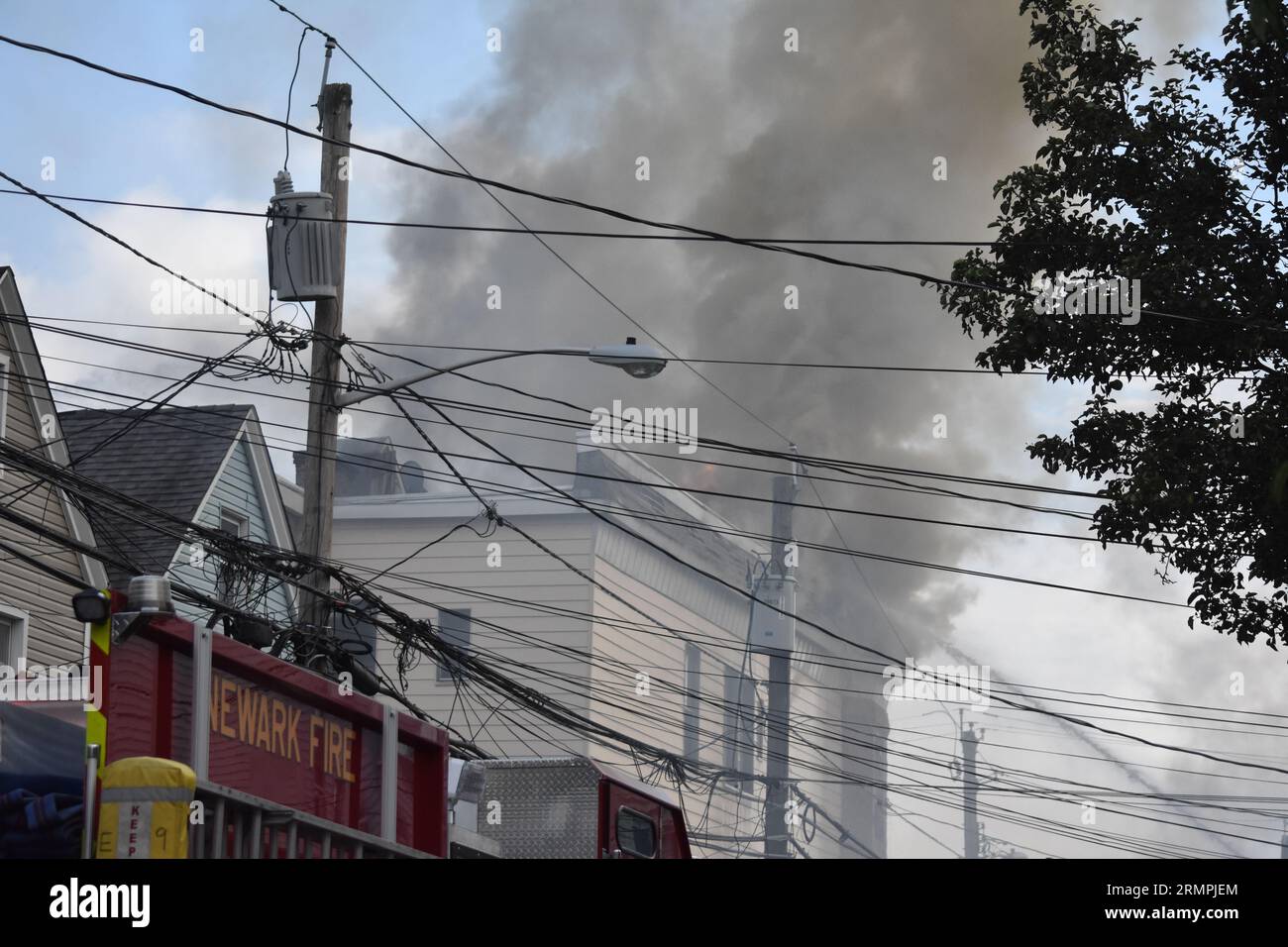 Newark, United States. 29th Aug, 2023. Flames shoot out of the roof of ...