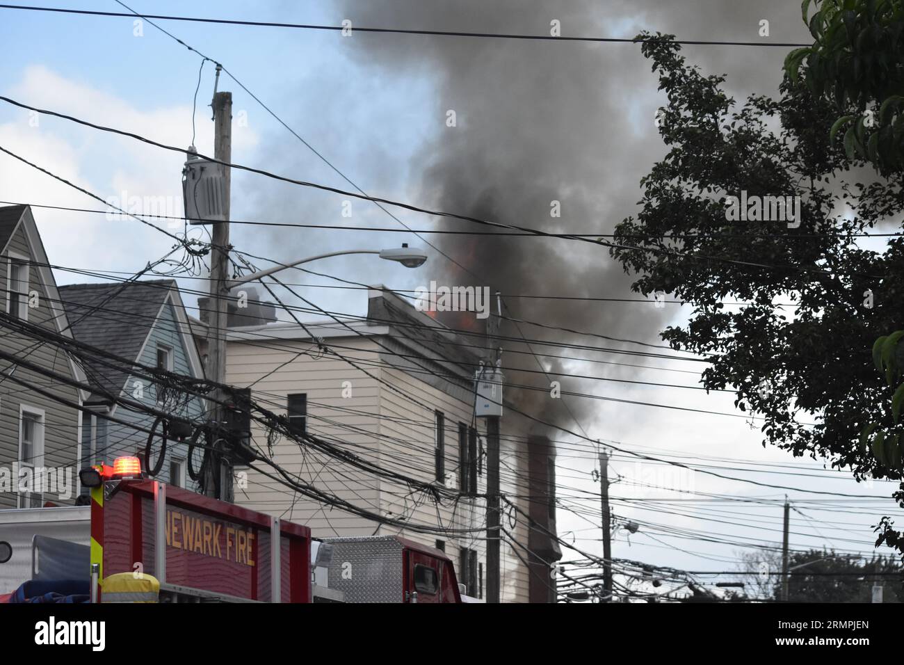 Newark, United States. 29th Aug, 2023. Flames shoot out of the roof of ...