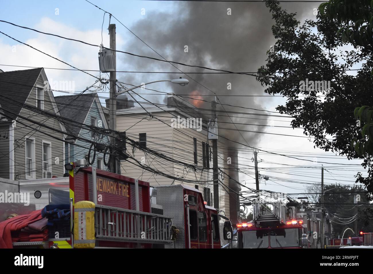 Newark, United States. 29th Aug, 2023. Flames shoot out of the roof of ...