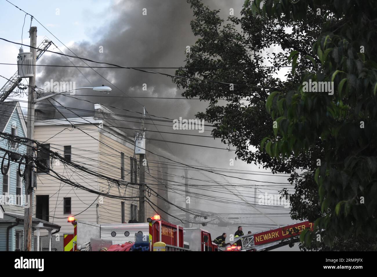 Newark, United States. 29th Aug, 2023. Flames shoot out of the roof of ...