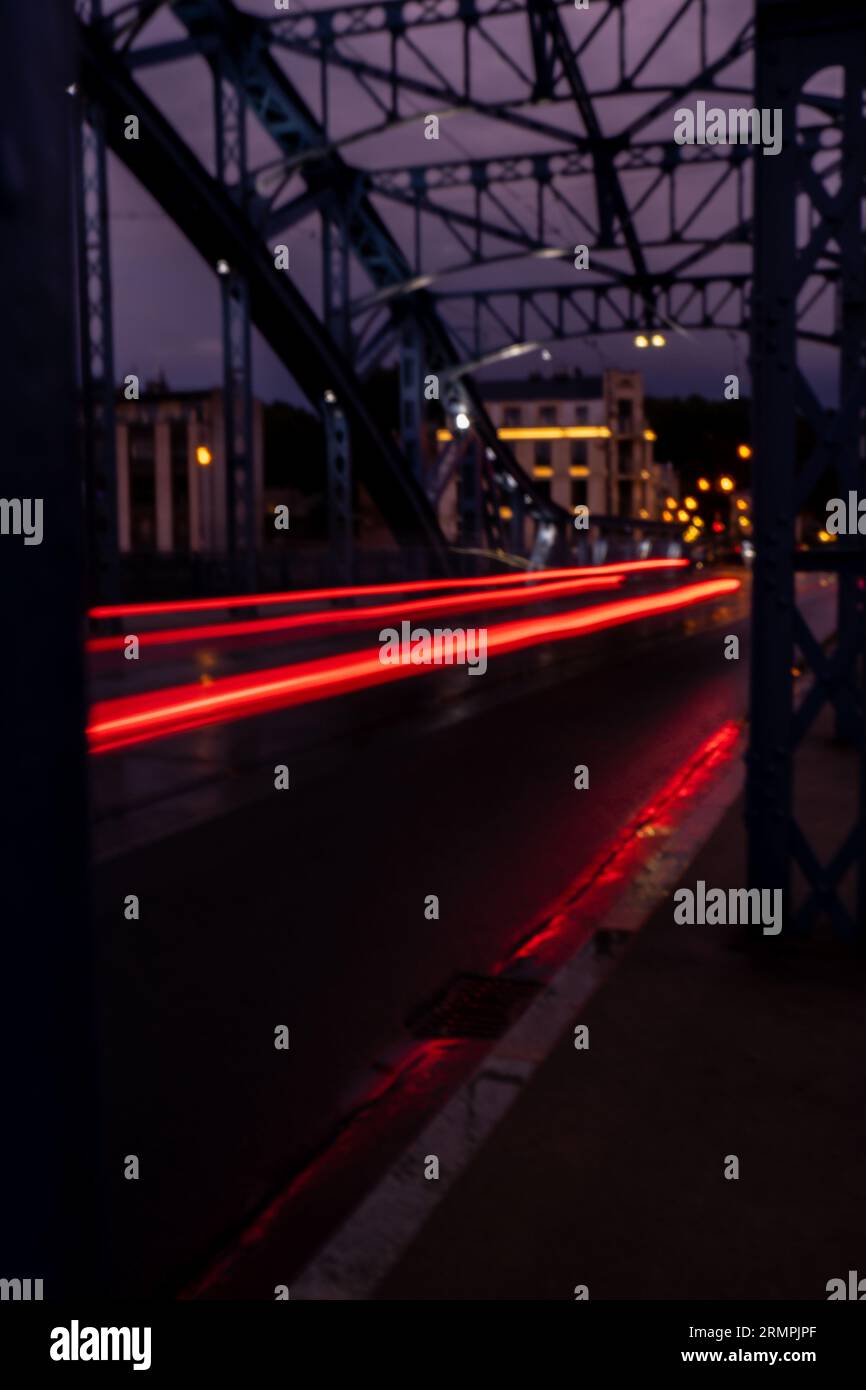 Defocused Lights of cars at night in Krakow bridge. Street line lights ...