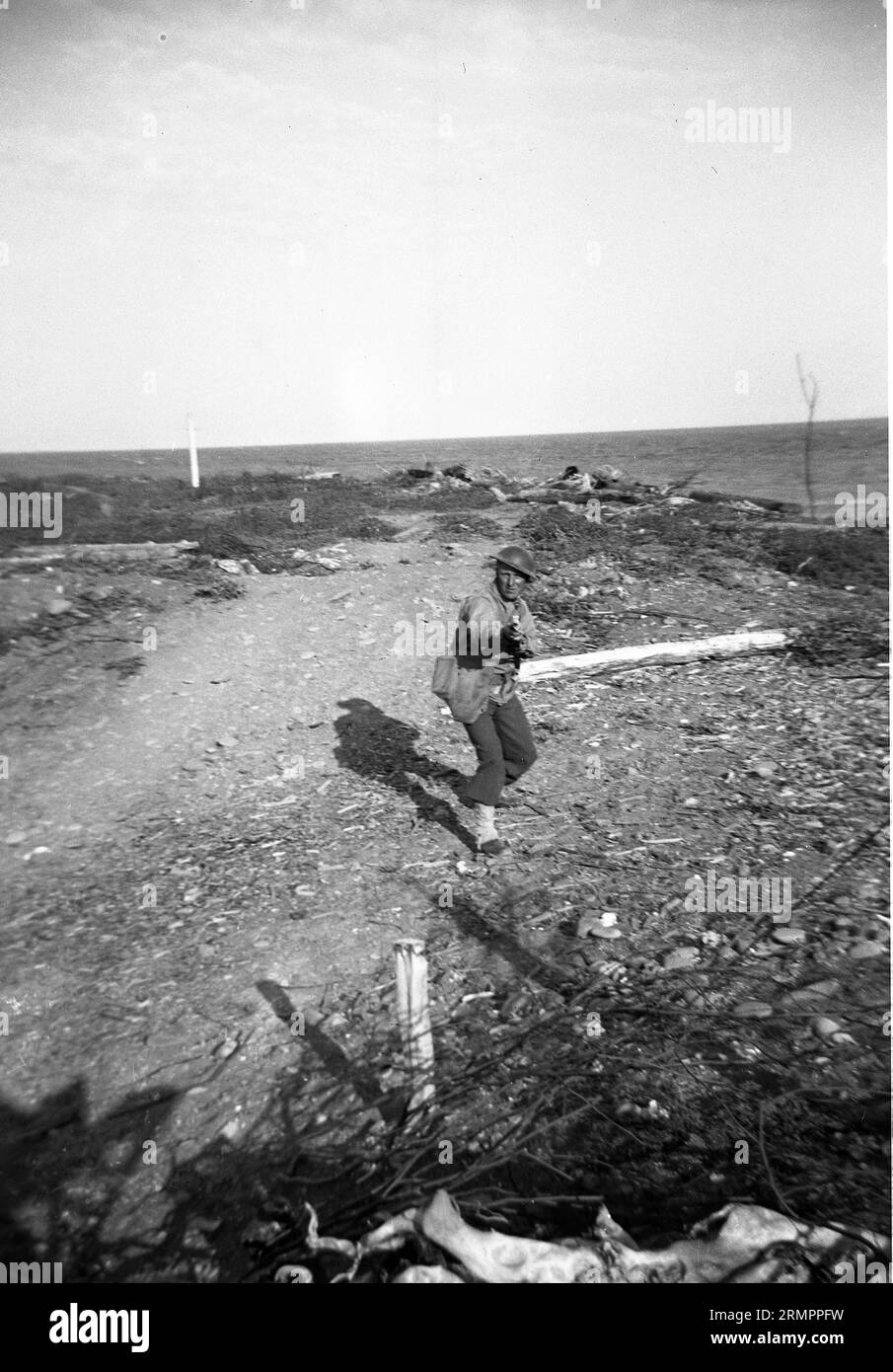 Solider pointing rifle at camera near ocean. Members of the United ...