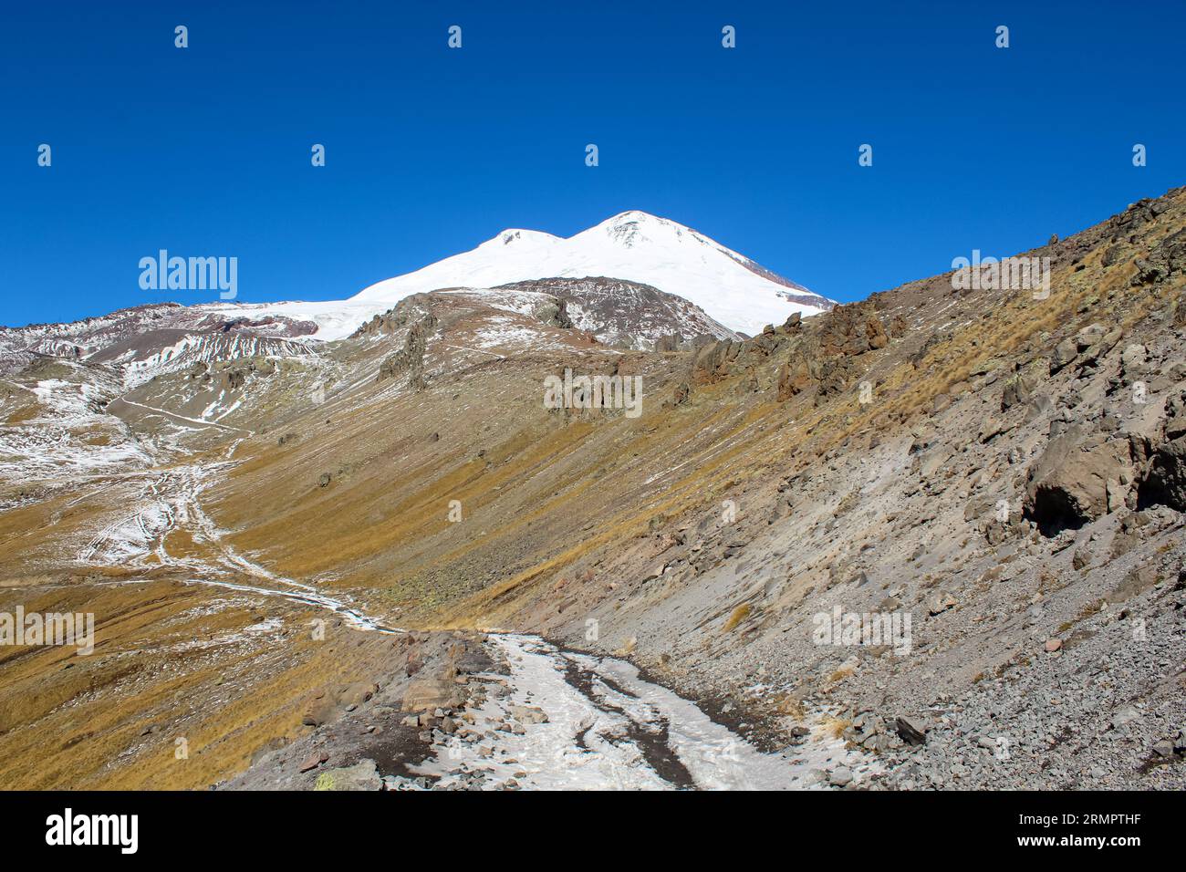 Double peak of Mount Elbrus, the highest mountain in Europe, blue sky ...