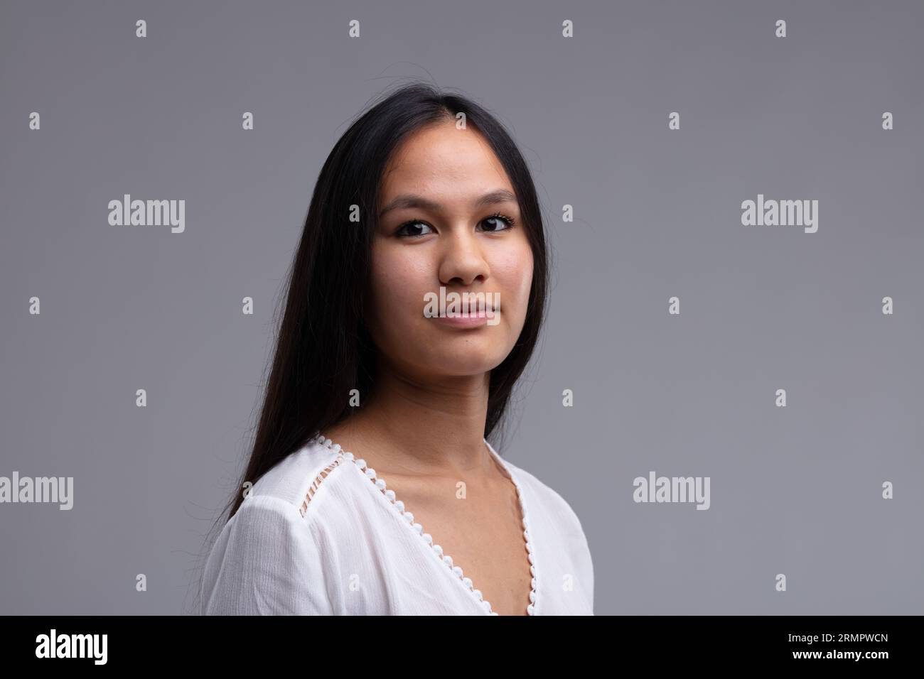 Beautiful young brunette woman with thick black hair, wearing white ...