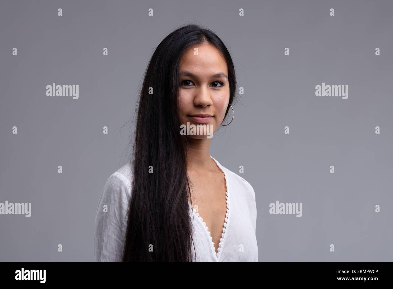 Portrait of a beautiful woman with long black hair, wearing a lacy ...