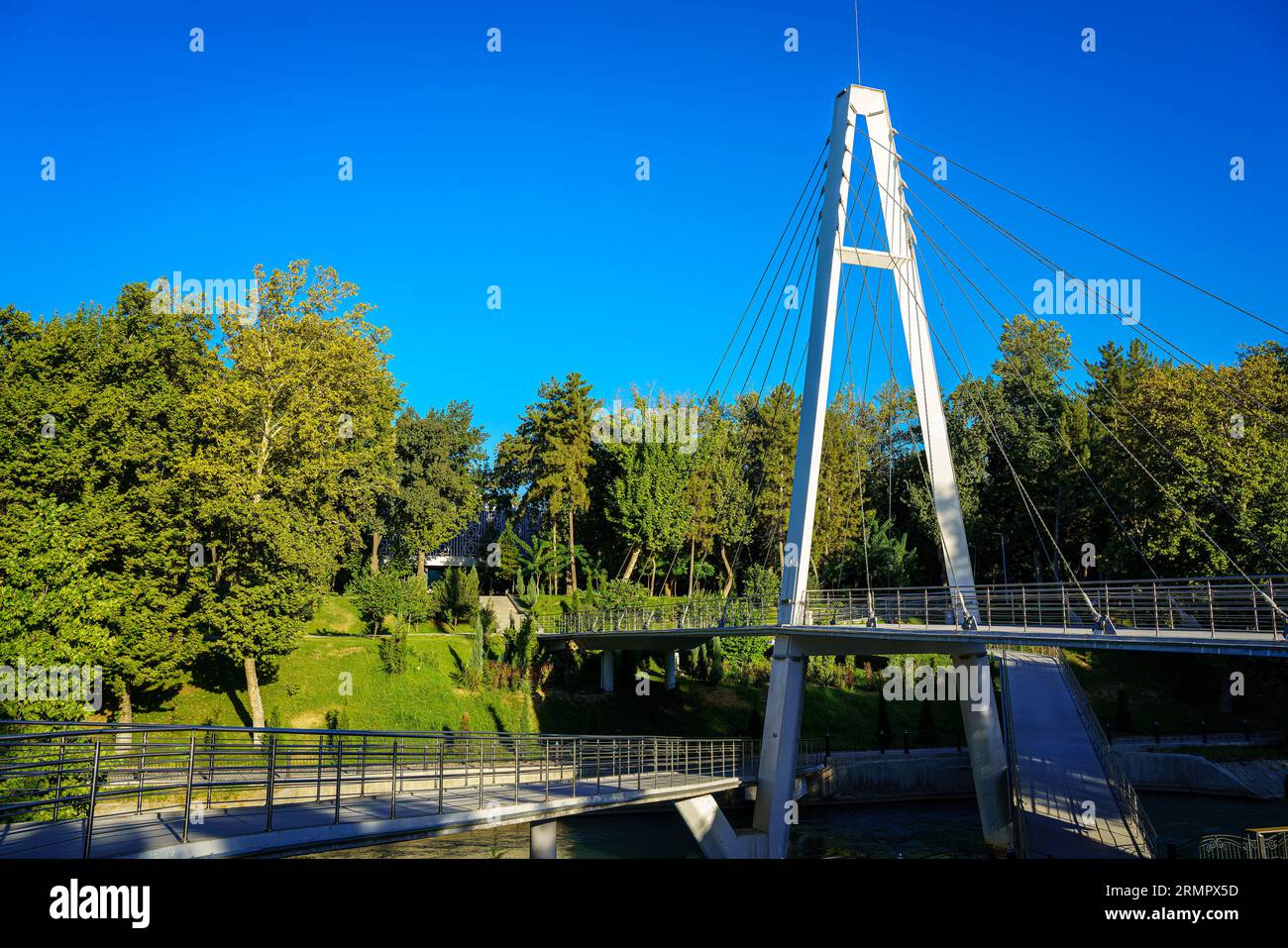 Modern footbridge with steel cables across the Anhor canal in Navruz ...