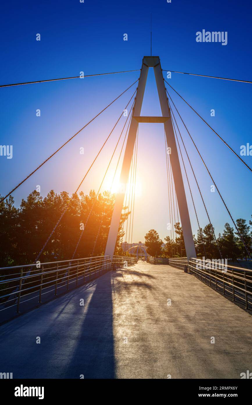 Modern footbridge with steel cables across the Anhor canal in Navruz ...