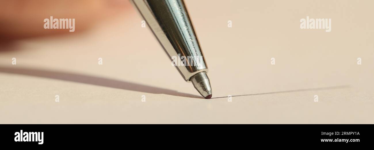 The macro roller of the ballpoint pen draws a line on paper Stock Photo ...