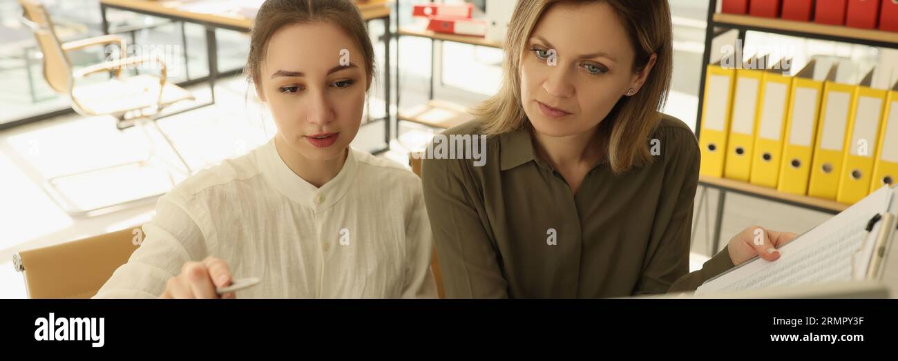 An employee in office teaches a woman computer literacy Stock Photo - Alamy