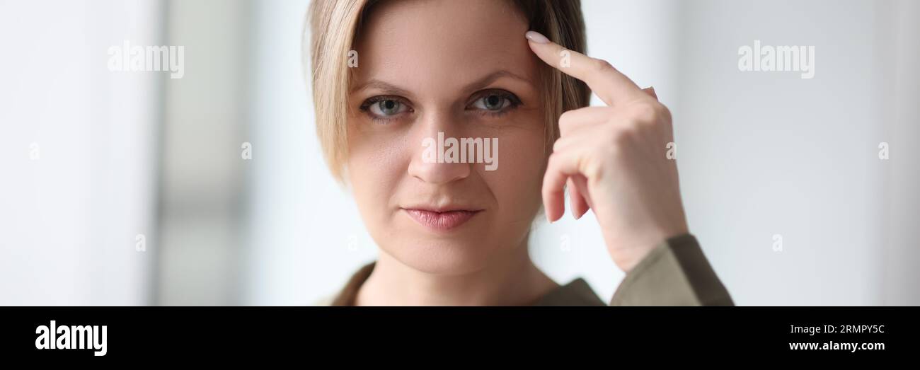 Portrait of a thinking woman with a finger on the forehead Stock Photo ...