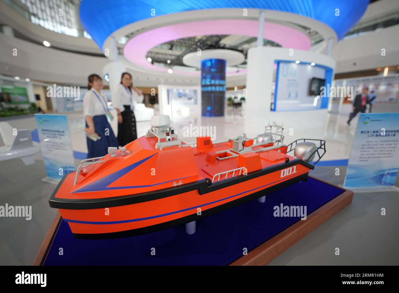 YANTAI, CHINA - AUGUST 29, 2023 - Visitors look at a model of an ...