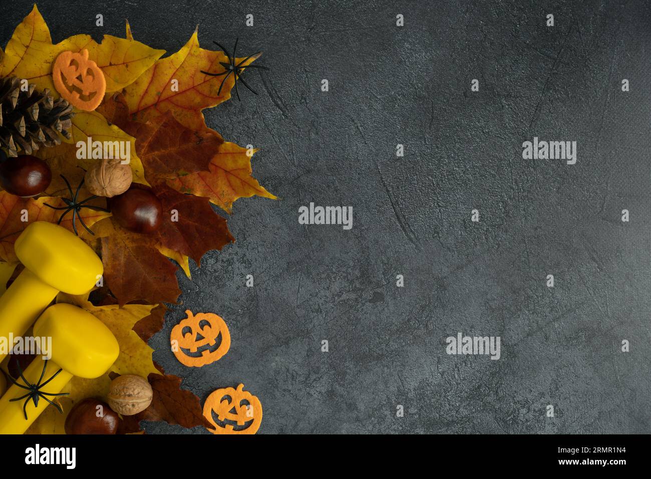 Dumbbells and Halloween decorations, autumn pumpkins, fall leaves ...
