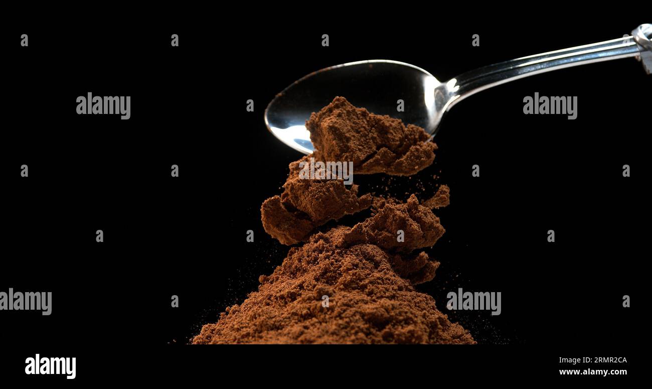 Nutmeg, myristica fragans, Powder falling from Spoon against Black ...