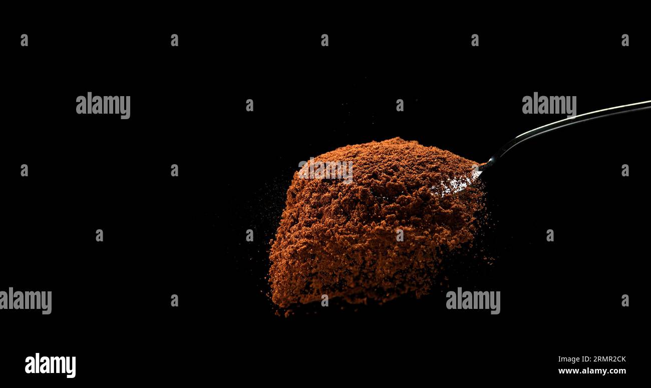 Nutmeg, myristica fragans, Powder falling from Spoon against Black ...