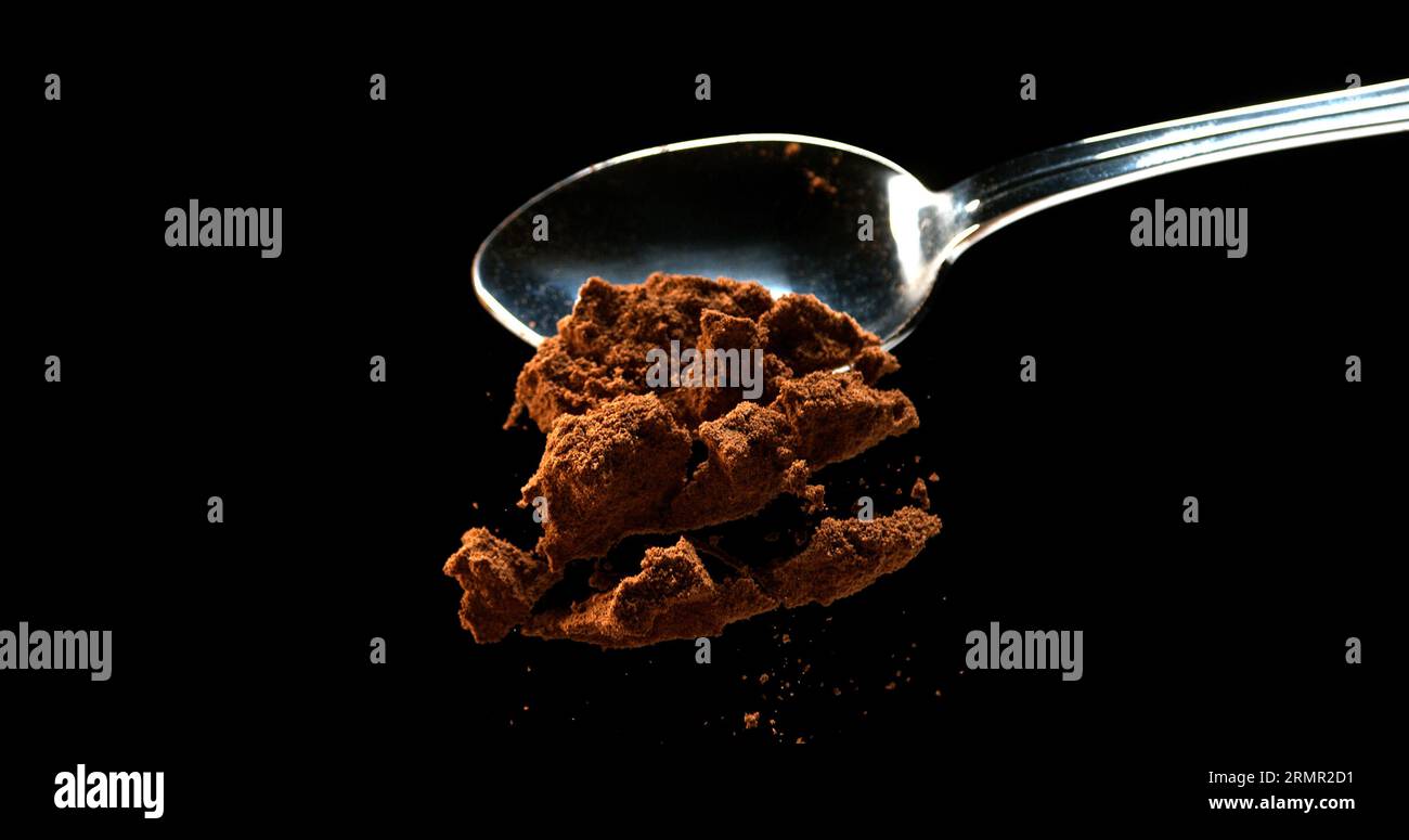 Nutmeg, myristica fragans, Powder falling from Spoon against Black ...