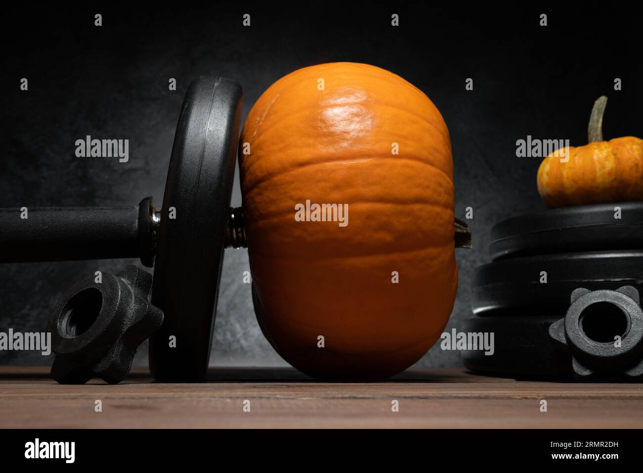 Dumbbell barbell and pumpkins as weight plates. Gym weightlifting ...