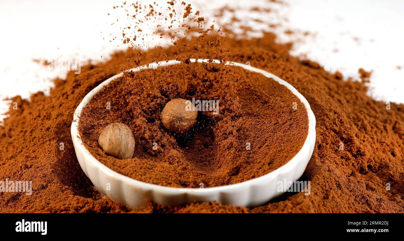 Nutmeg, myristica fragans, Nut falling on Powder against White ...