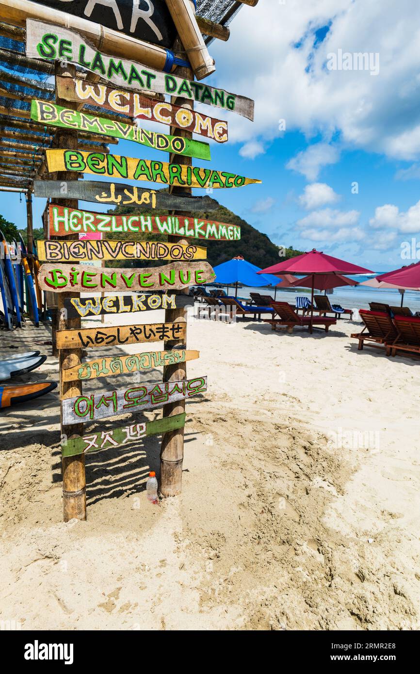 Beach hut for surfers with welcome sign in many languages. Beach house ...