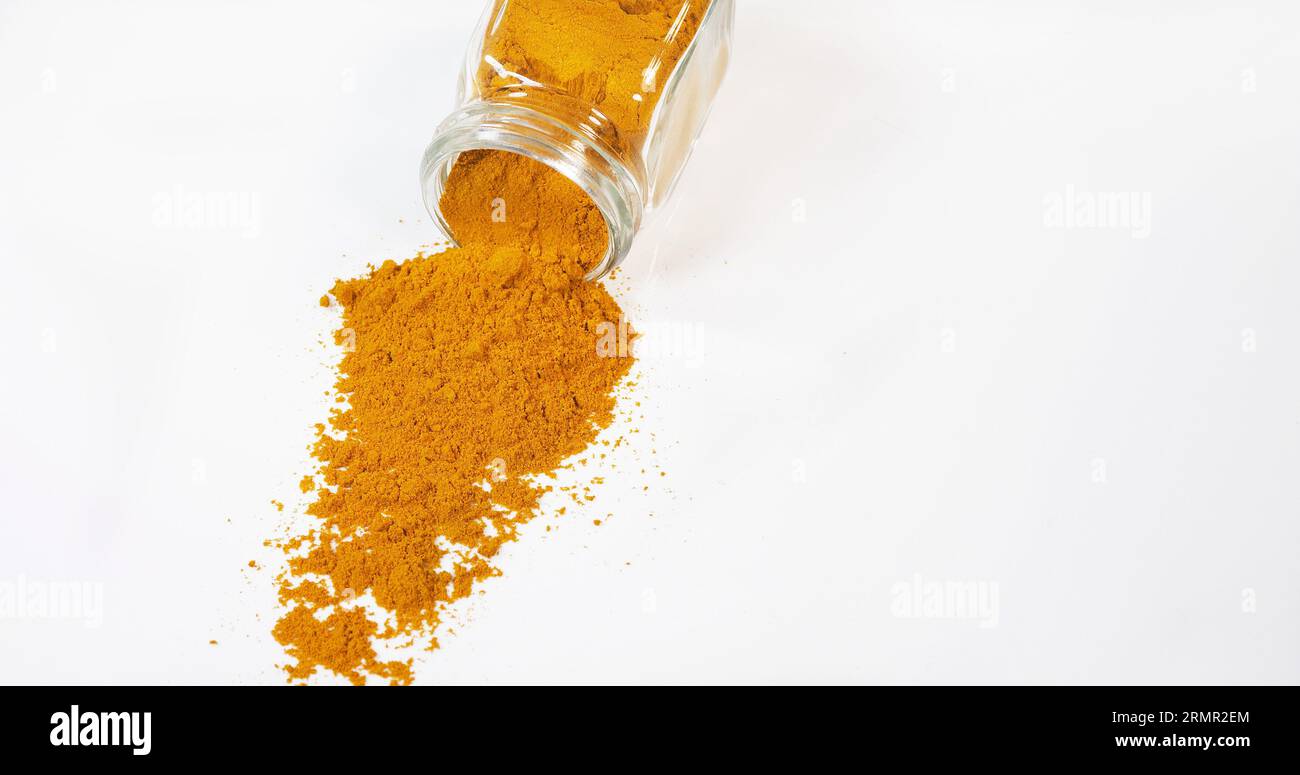 Curry Powder falling against white background Stock Photo - Alamy