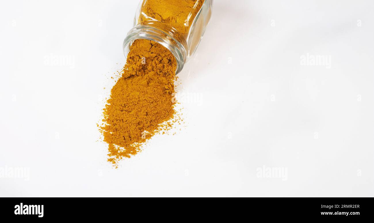 Curry Powder falling against white background Stock Photo - Alamy