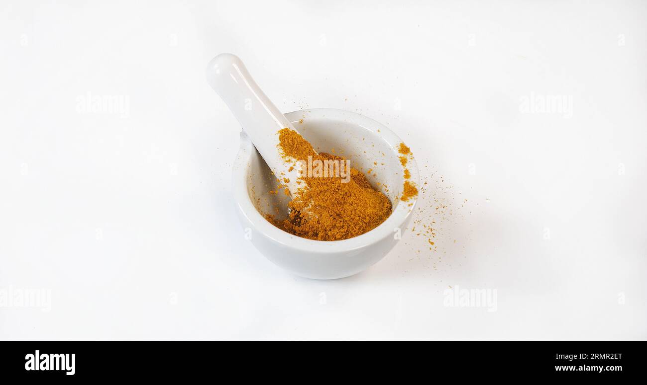 Curry Powder falling against white background Stock Photo - Alamy