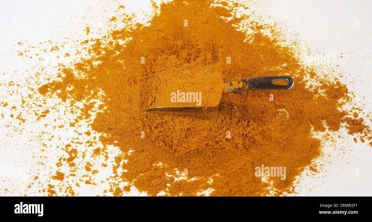 Curry Powder falling against white background Stock Photo - Alamy
