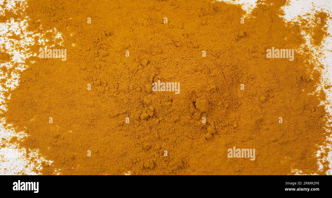Curry Powder falling against white background Stock Photo - Alamy