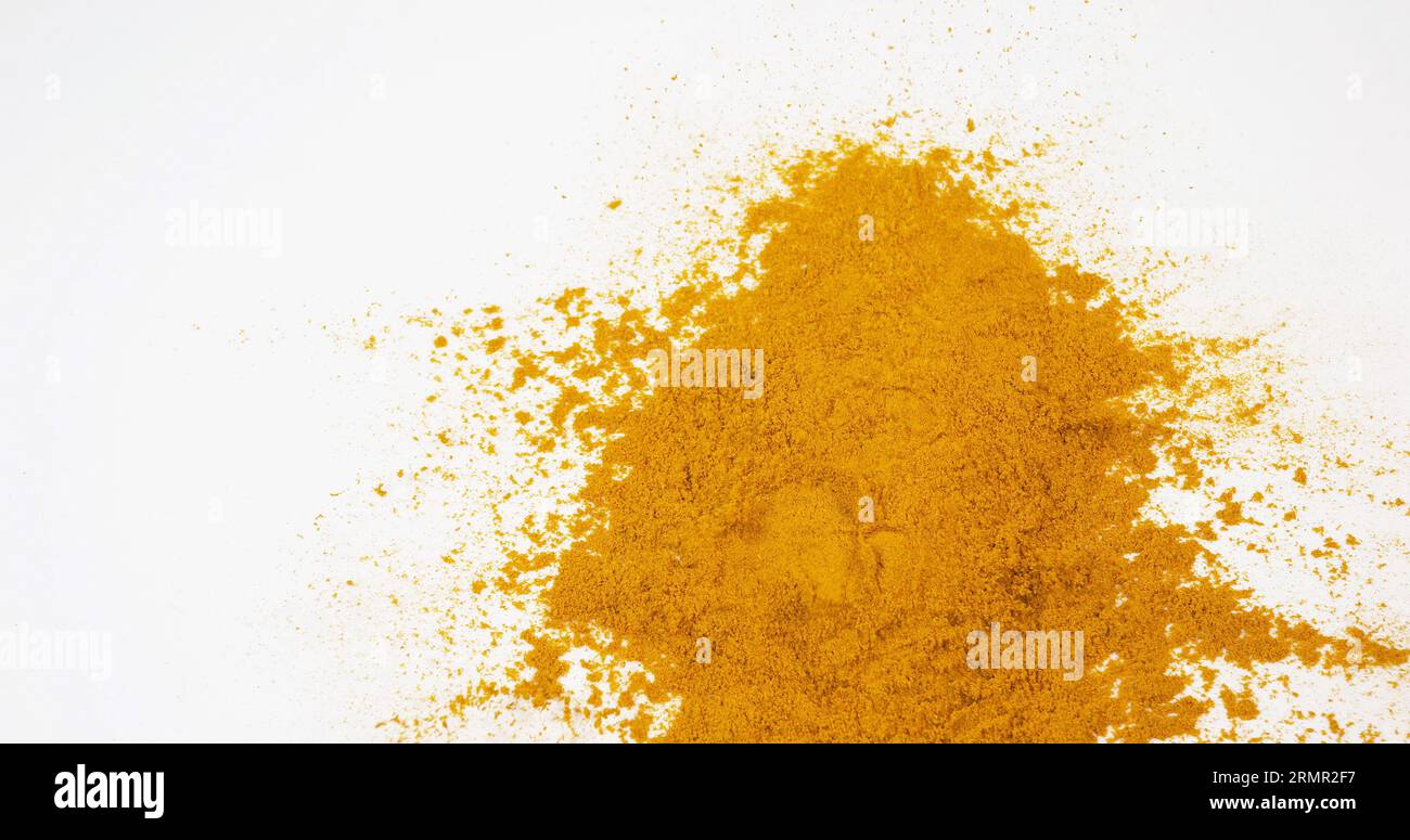Curry Powder falling against white background Stock Photo - Alamy