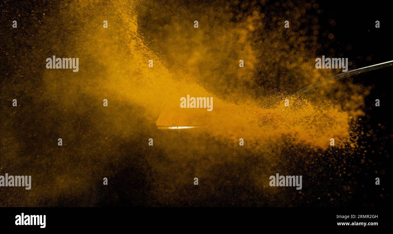 Spoon and Curry Powder falling from Spoon against Black Background ...