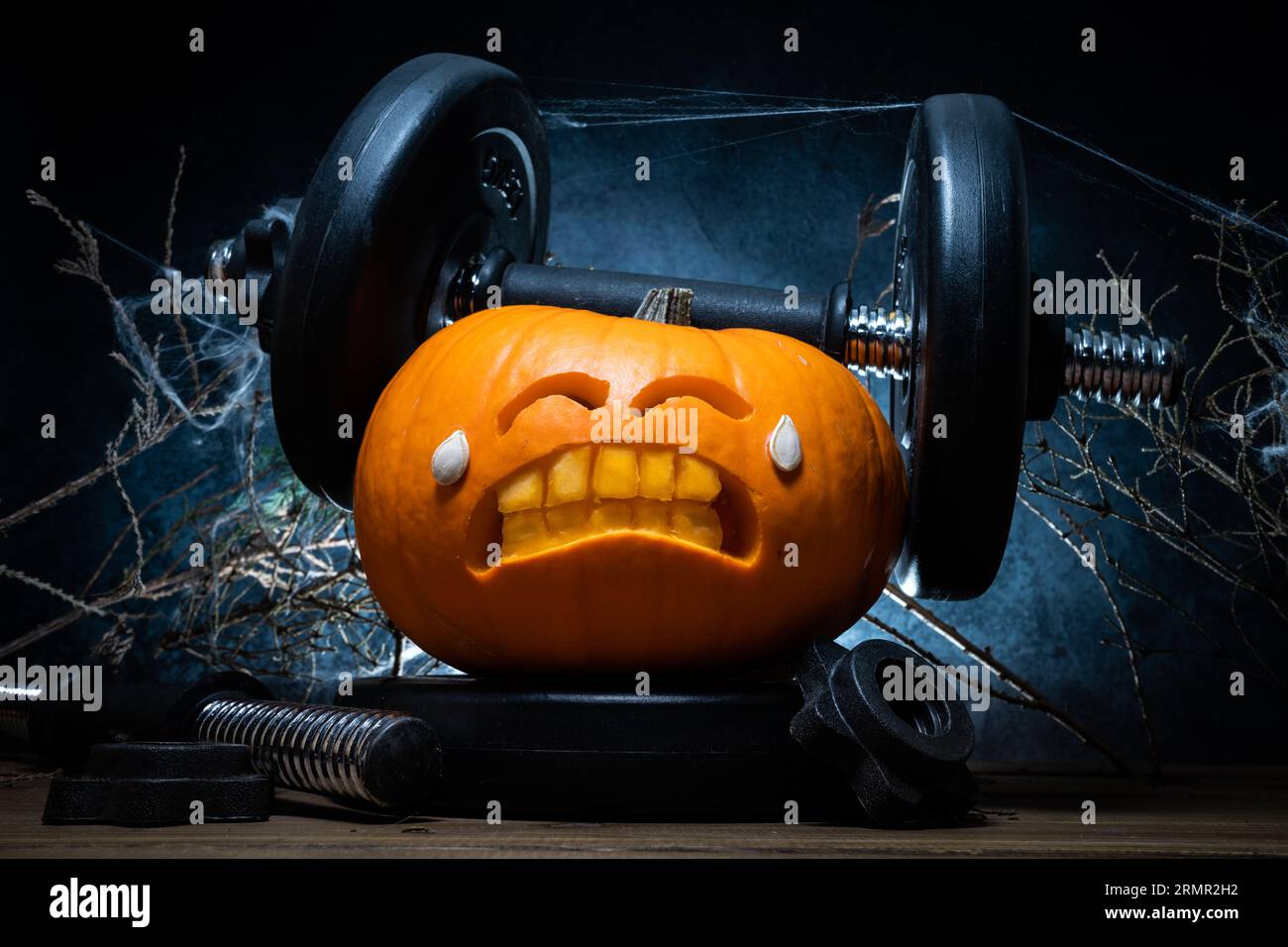 Halloween pumpkin lifting heavy barbell dumbbell. Weightlifting carving ...
