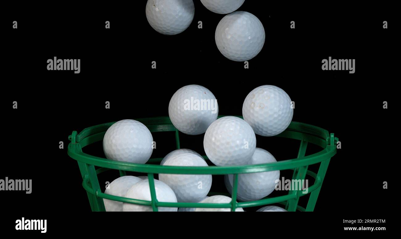 Golf's Balls falling against Black background Stock Photo - Alamy