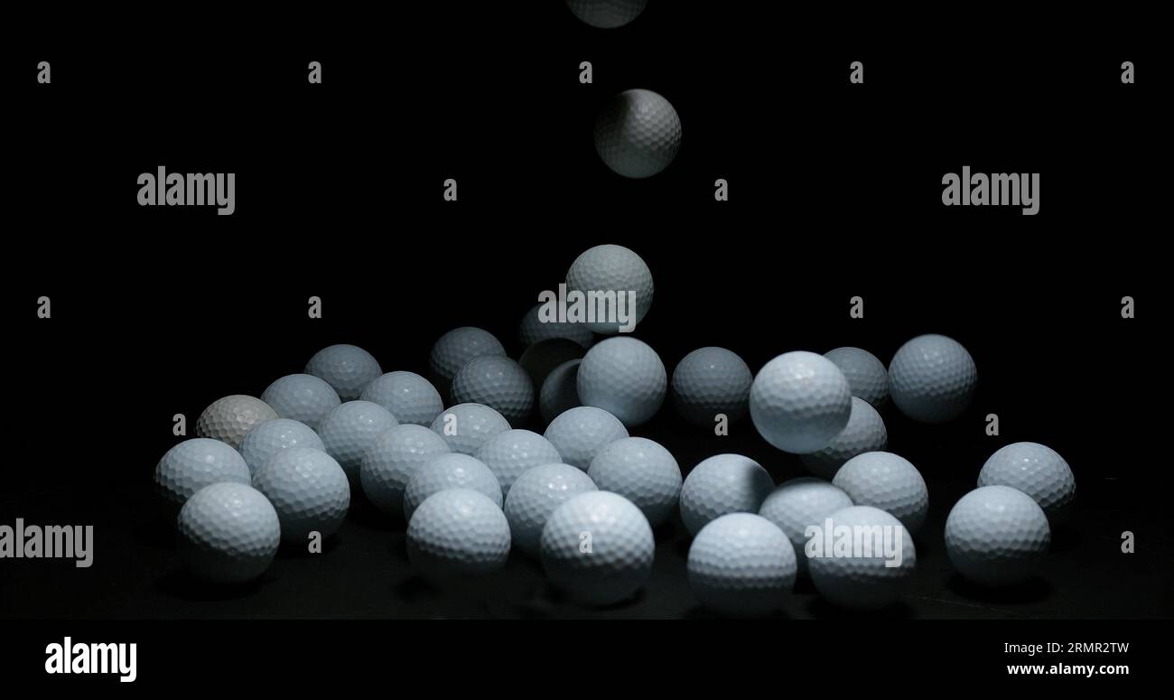 Golf's Balls falling against Black background Stock Photo - Alamy