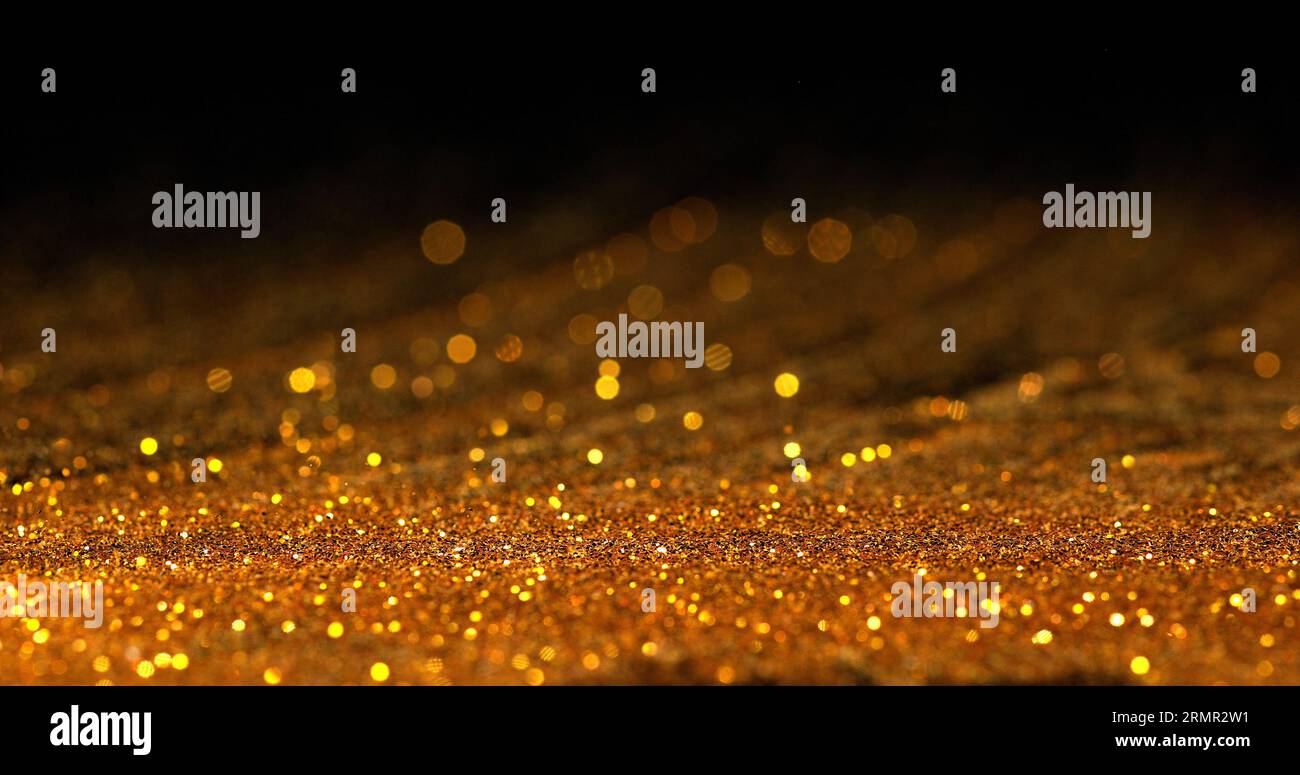 Gold Powder falling against Black Background Stock Photo - Alamy