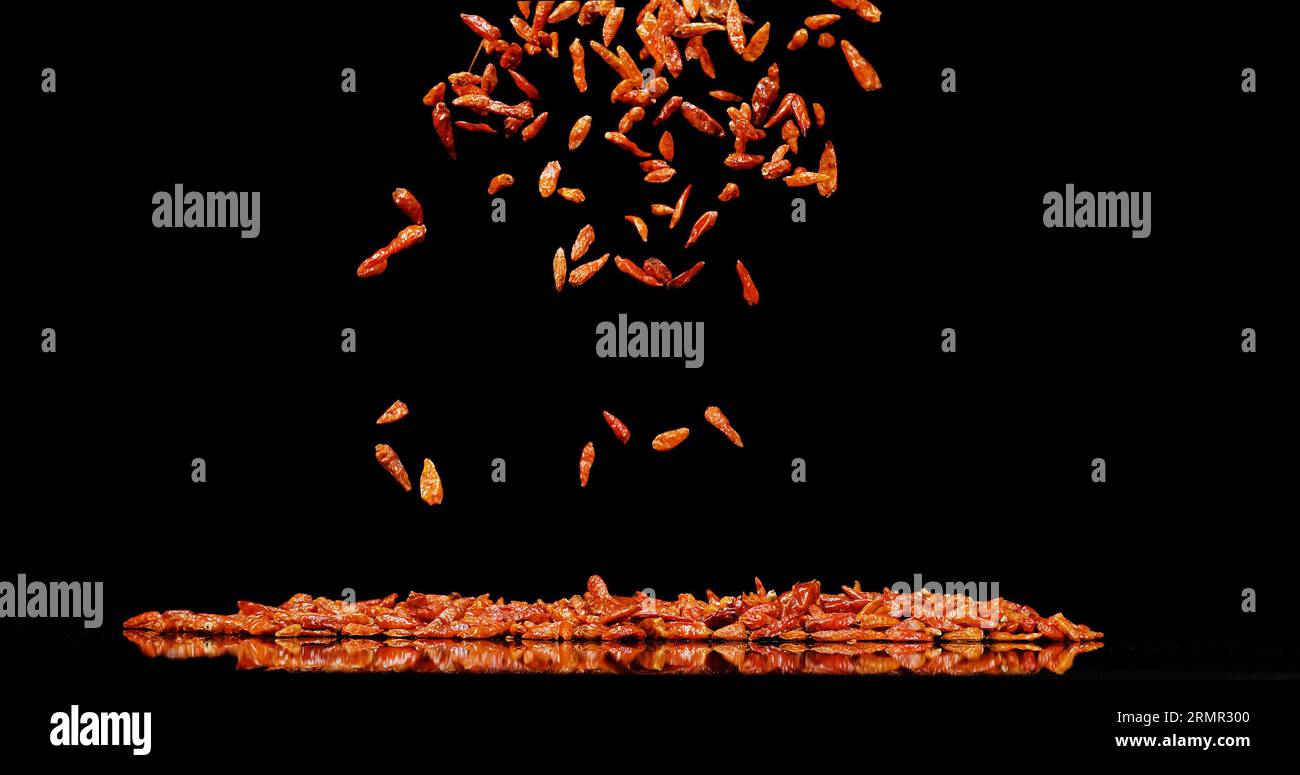 Cayenne Chili Pepper, capsicum frutescens, spice falling against Black ...